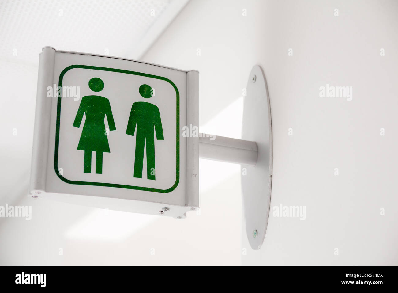 Public modern white and green restroom sign on white wall Stock Photo ...