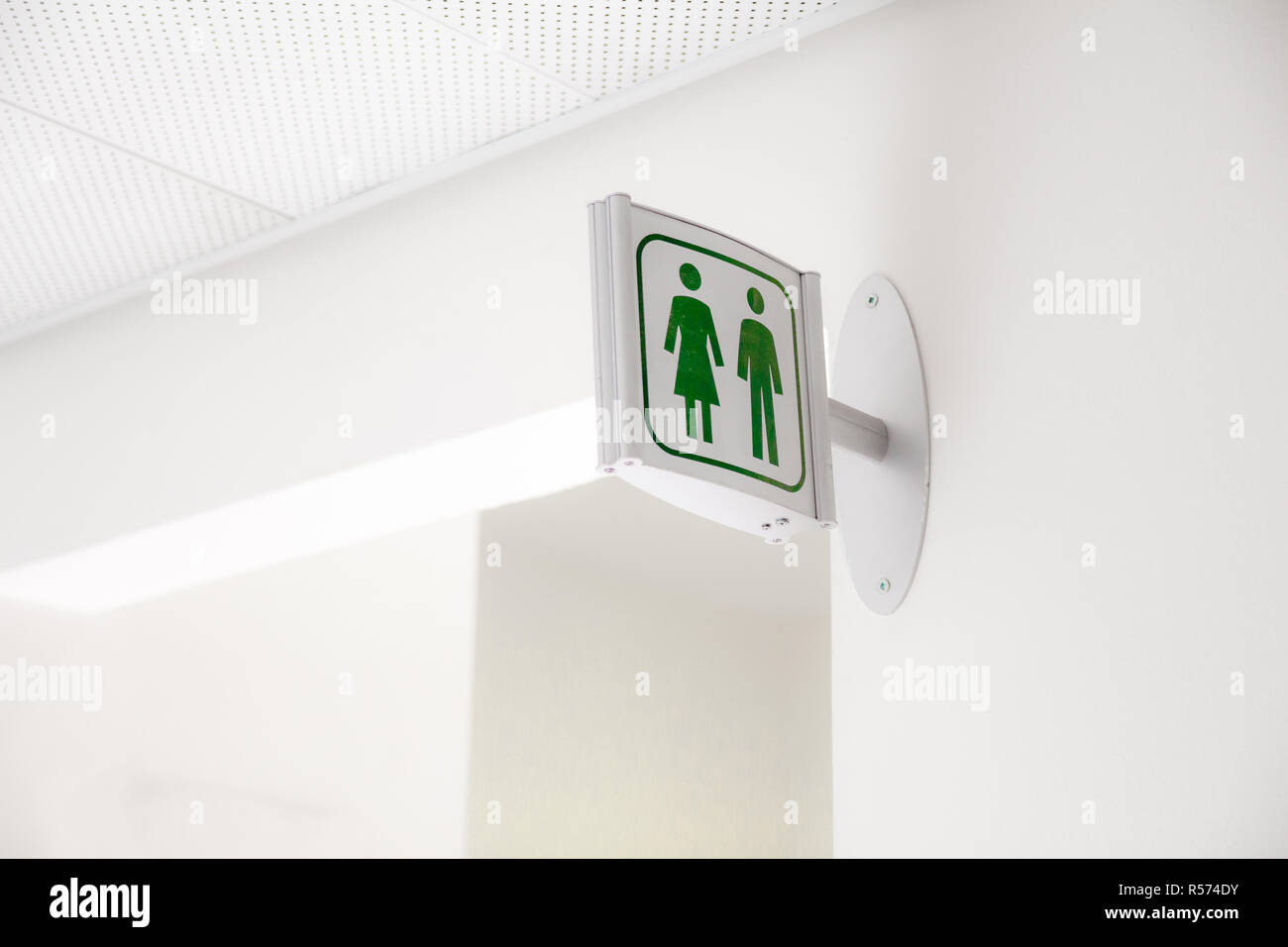 Public modern white and green restroom sign on white wall Stock Photo ...