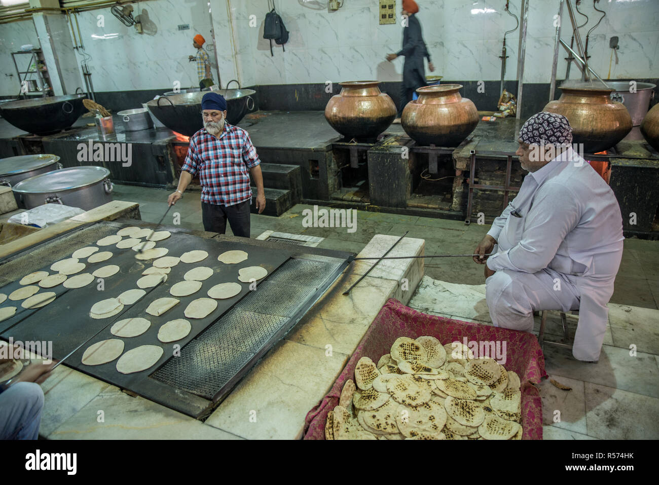 Volunteers preparing langar (free food) at Gurudwara Bangla Sahib Sikh ...