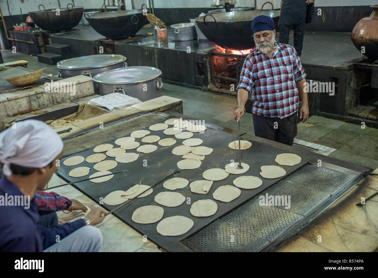 Volunteers preparing langar (free food) at Gurudwara Bangla Sahib Sikh ...