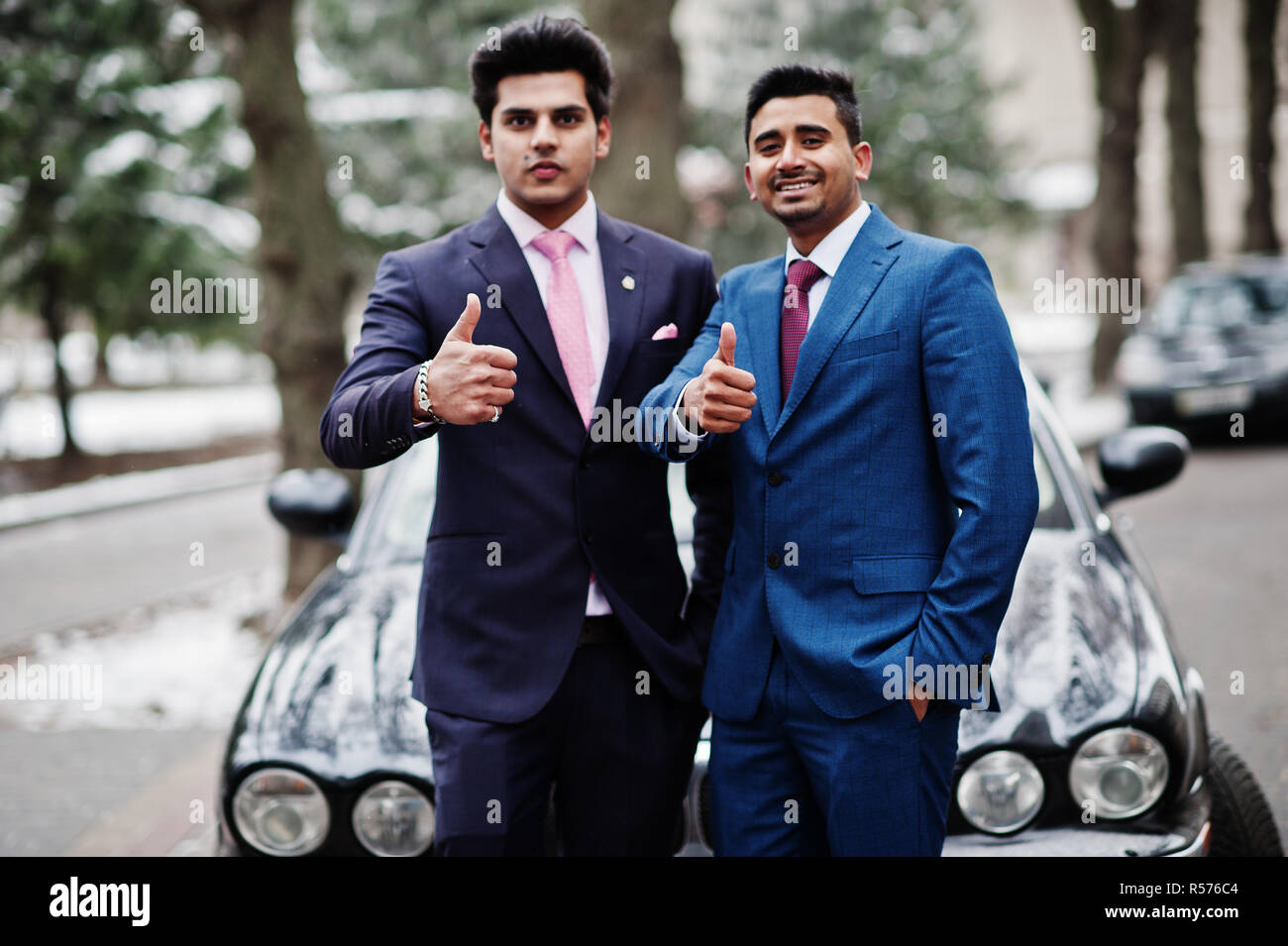 Two elegant indian fashionable mans model on suit posed at winter day ...