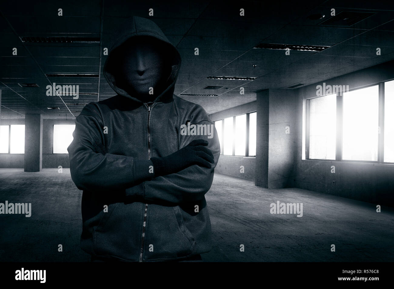 Hooded man with mask standing alone Stock Photo - Alamy