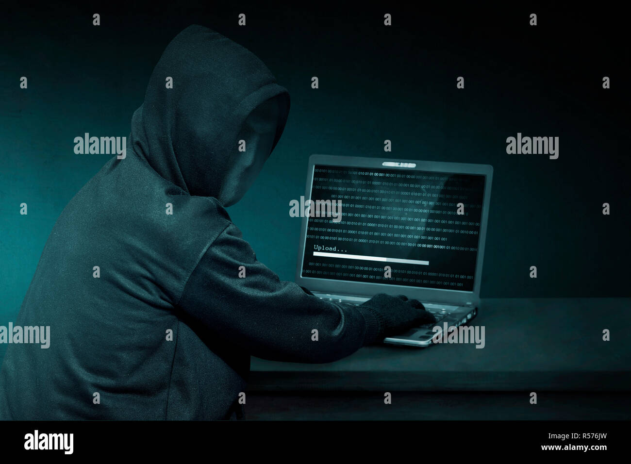 Hooded hacker with anonymous mask using laptop to steal data Stock ...