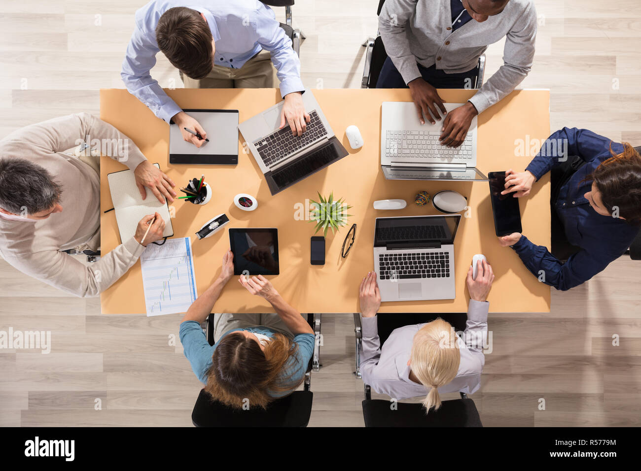 Group Of People Working At Workplace Stock Photo - Alamy