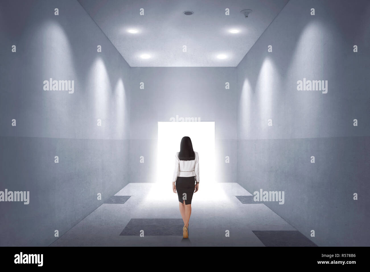 Back view of a young asian business woman walking to opened door Stock ...