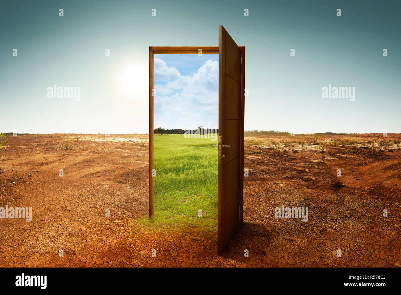 Open wooden door to the new world with green environment Stock Photo ...