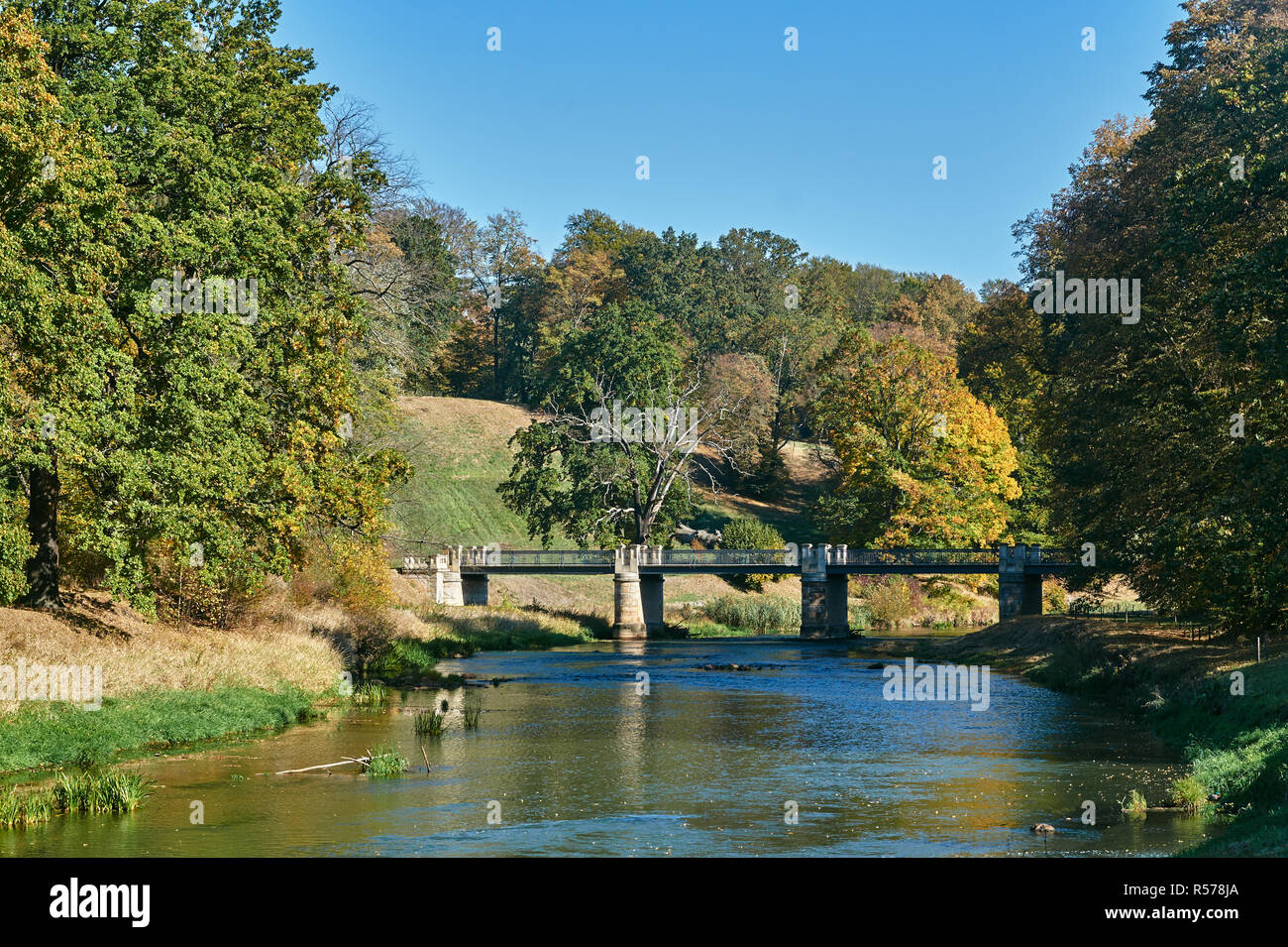 historic bridge over the Nysa Łużycka river during autumn on the border ...