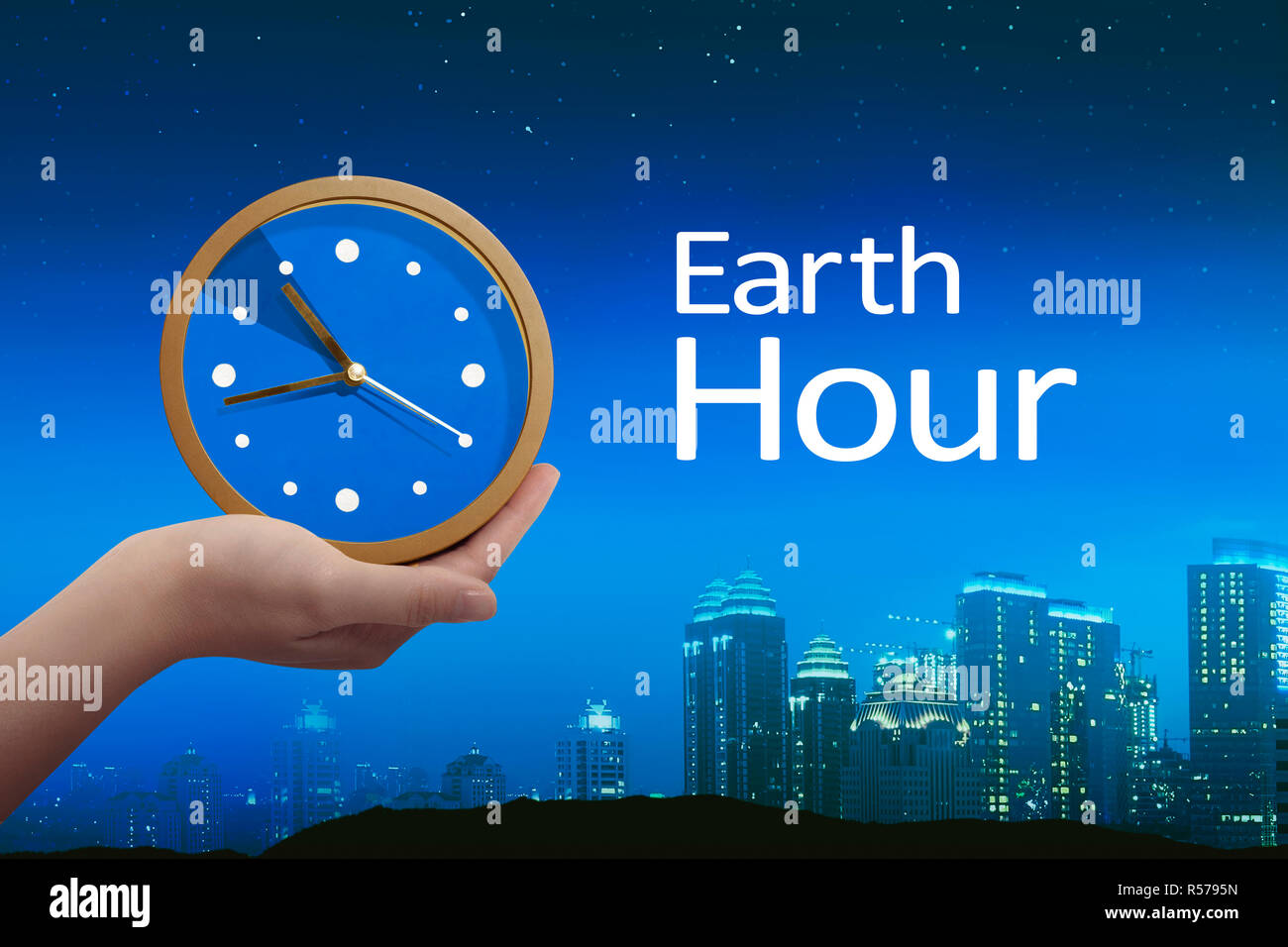 People hand holding clock with earth hour greeting Stock Photo - Alamy