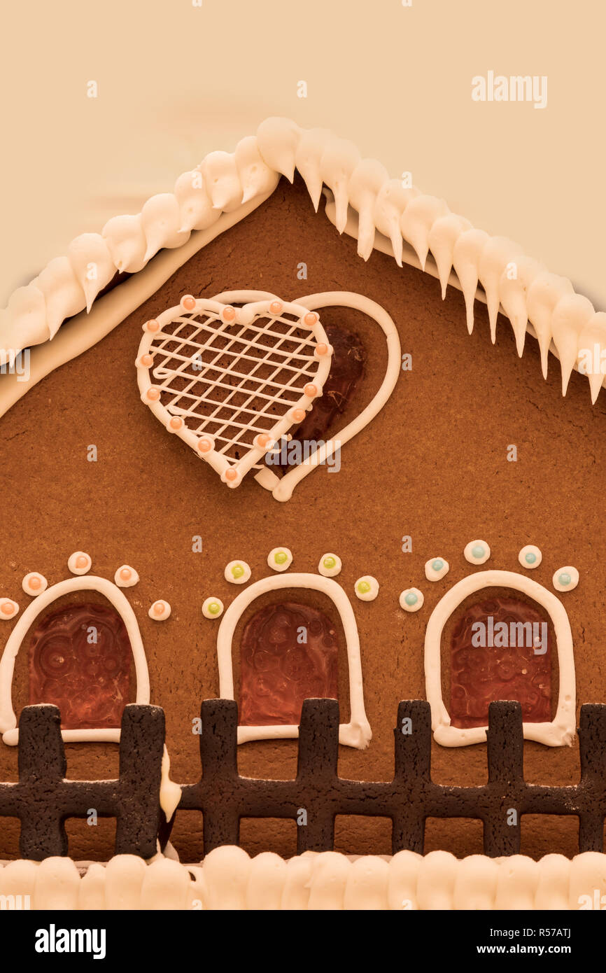 Gingerbread house with white icing and heart shaped windows with ...