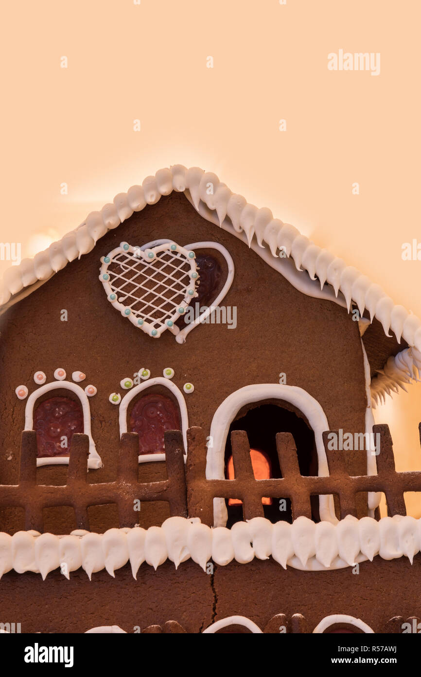 Gingerbread house with white icing and heart shaped windows with ...