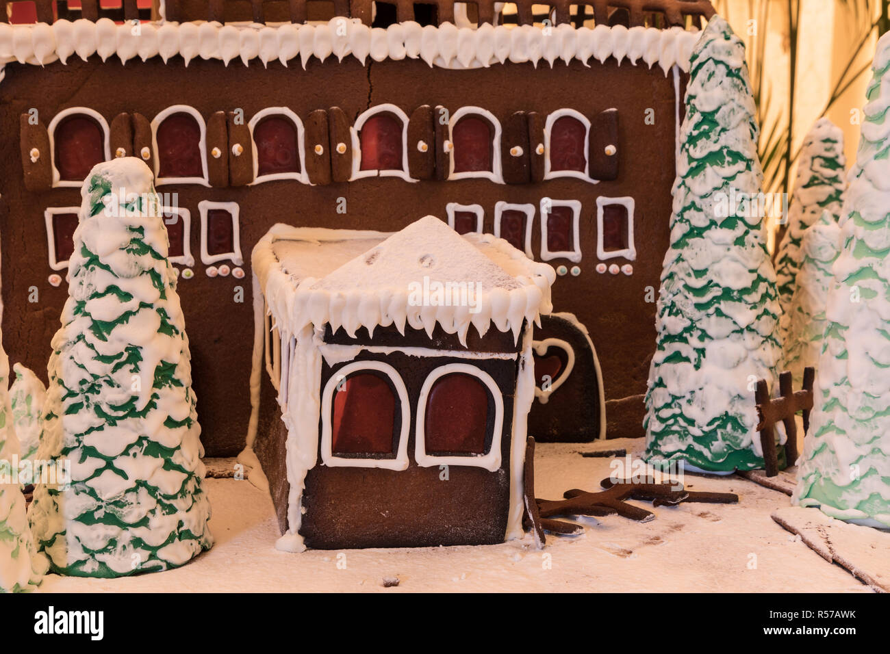 Gingerbread house with white icing and heart shaped windows with ...