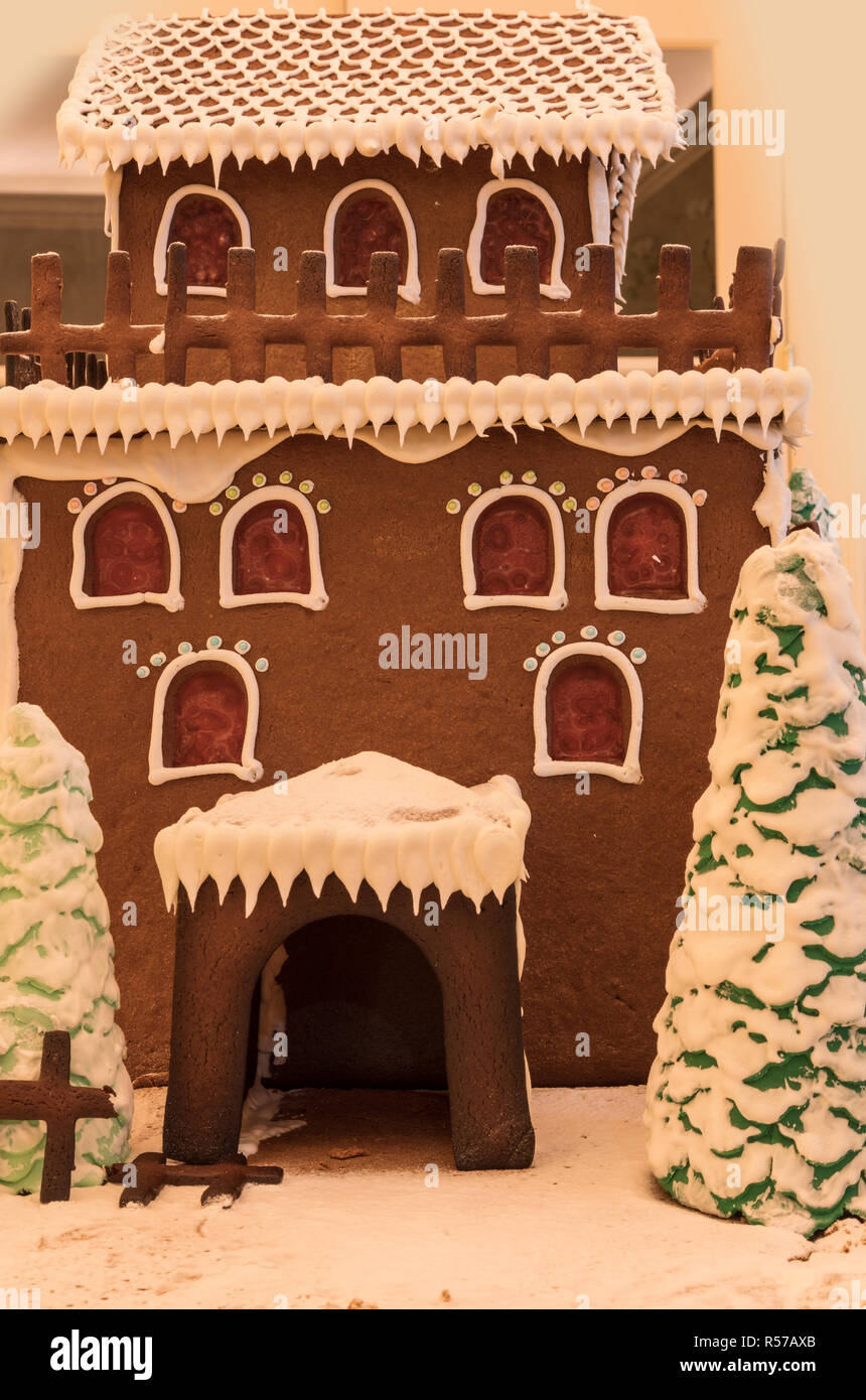 Gingerbread house with white icing and heart shaped windows with ...