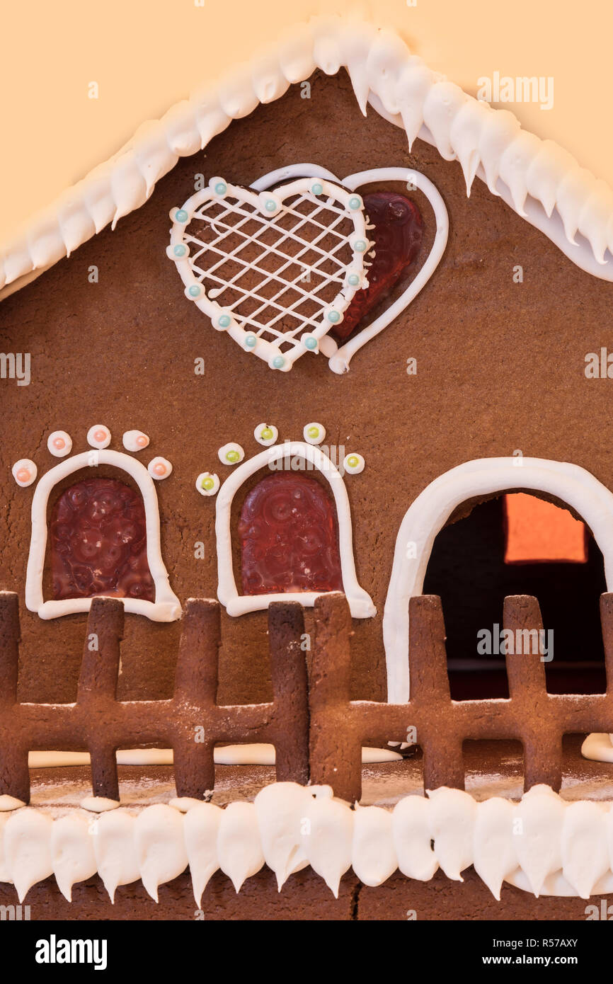 Gingerbread house with white icing and heart shaped windows with ...