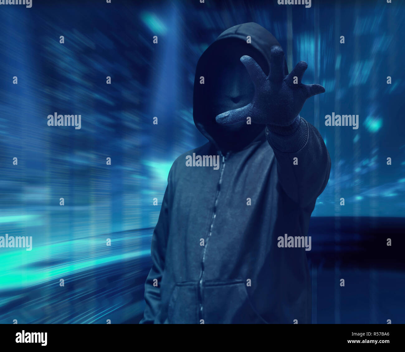 Hacker man with anonymous mask grabbing something Stock Photo - Alamy