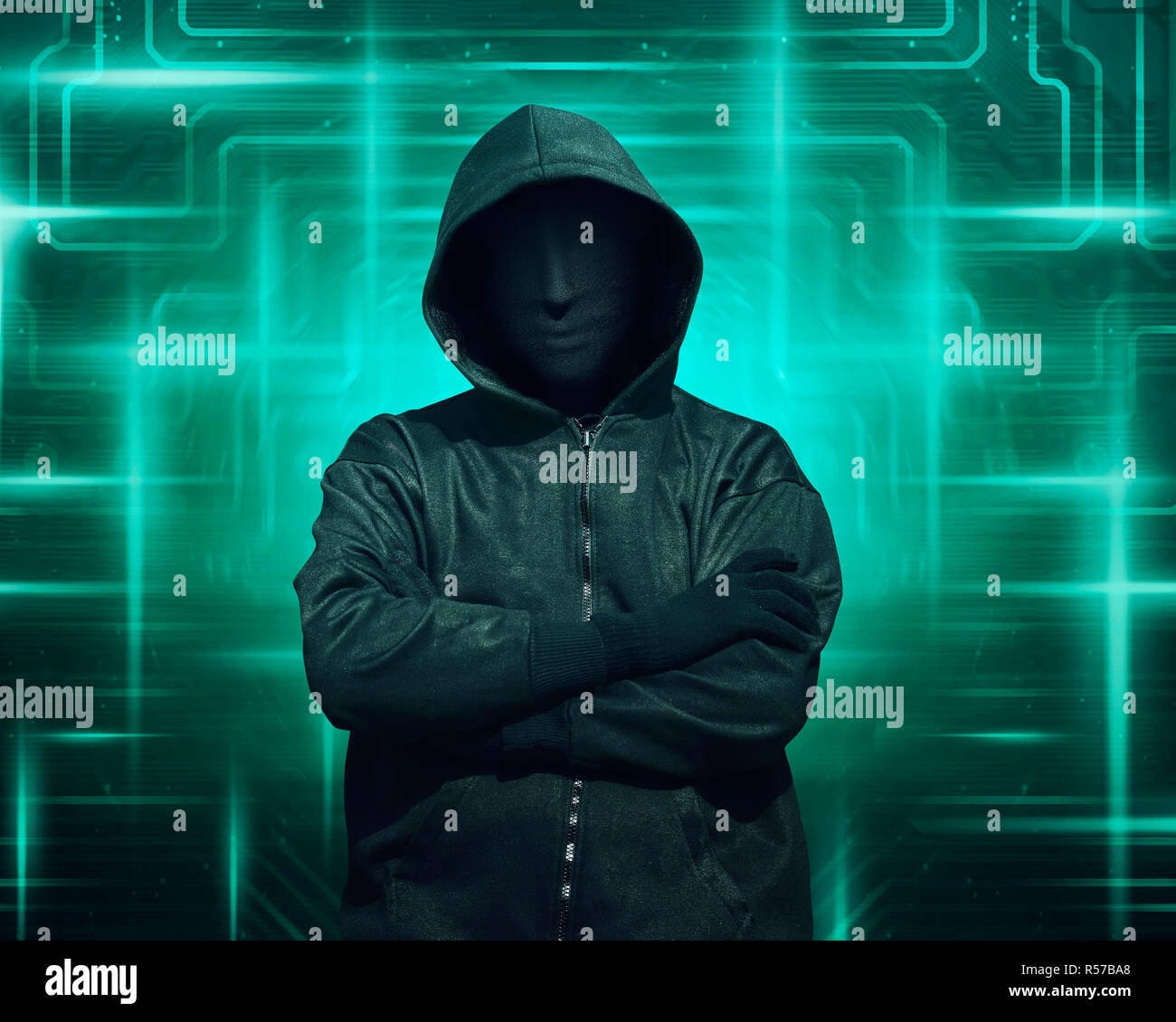 Hooded hacker with mask standing Stock Photo - Alamy