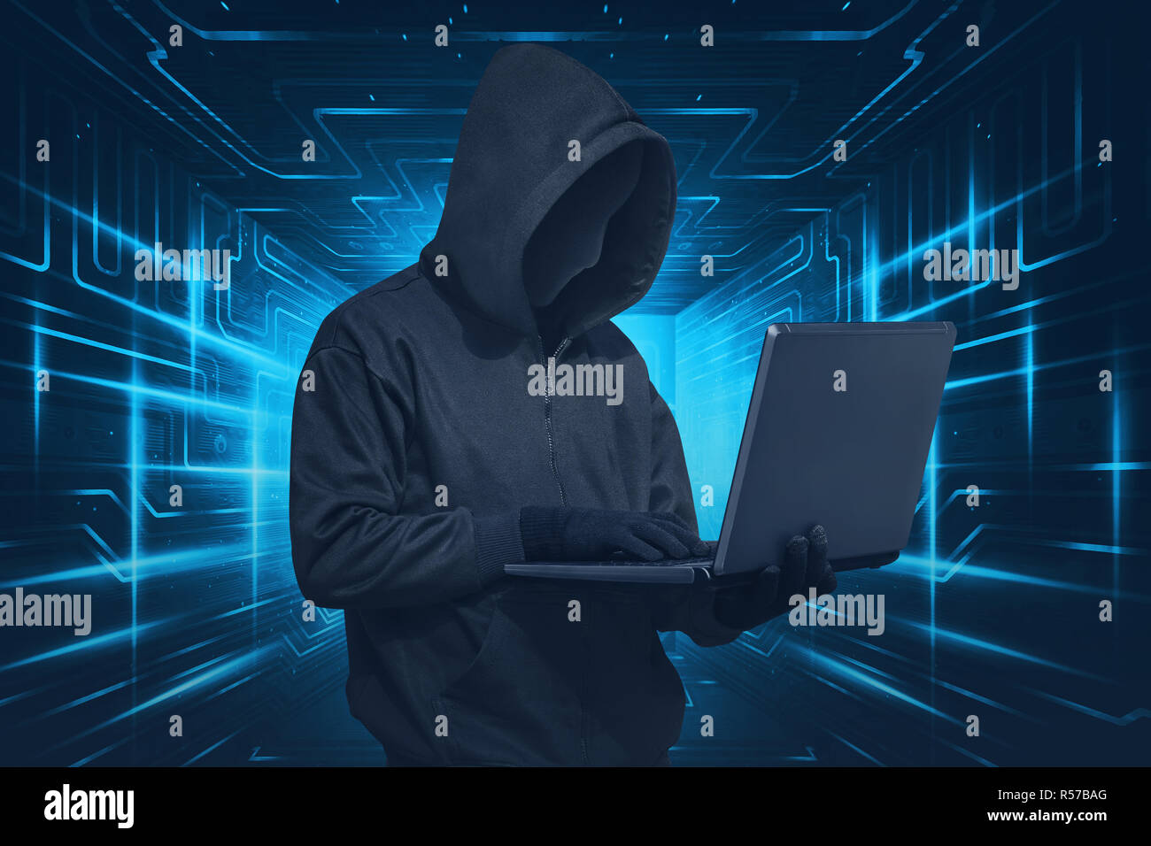 Hacker man with mask using laptop while standing Stock Photo - Alamy