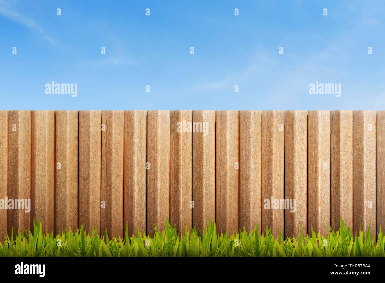 Green grass field with wooden fence Stock Photo - Alamy