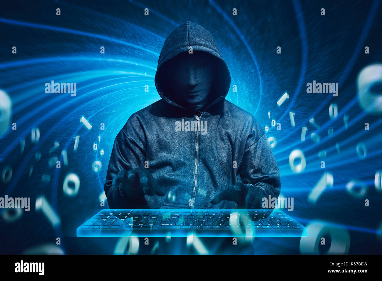 Hooded hacker with mask typing on virtual keyboard Stock Photo - Alamy