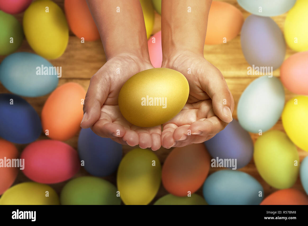 People hand holding gold Easter eggs Stock Photo - Alamy
