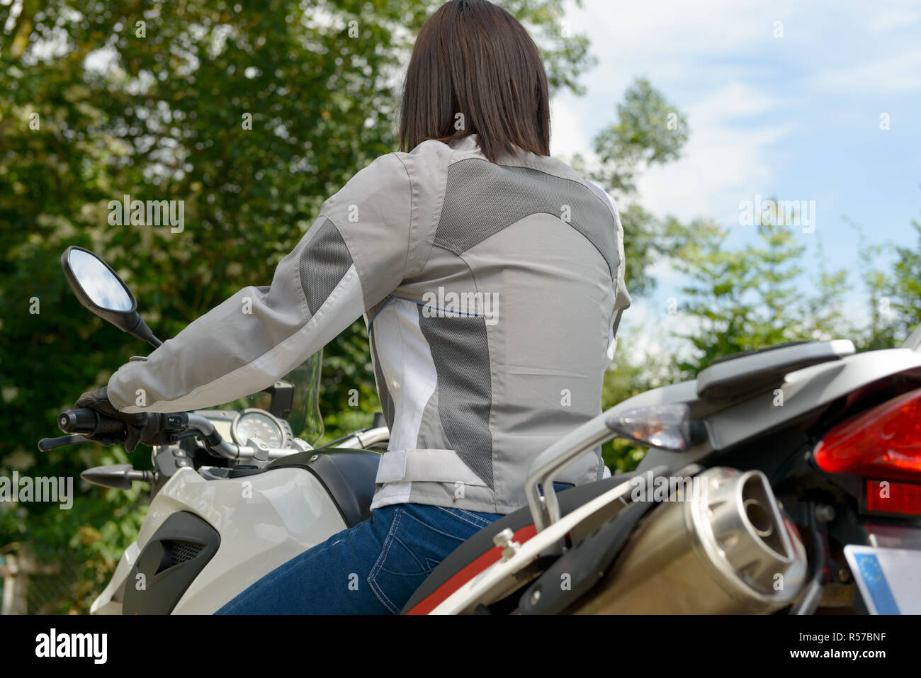 girl sitting on a motorcycle, back view Stock Photo - Alamy