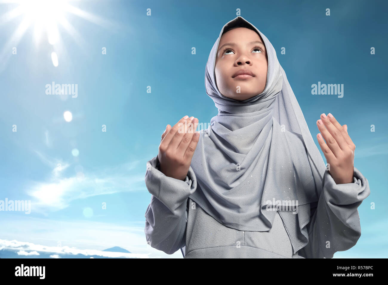 Religious asian muslim kid raising hand and praying Stock Photo - Alamy