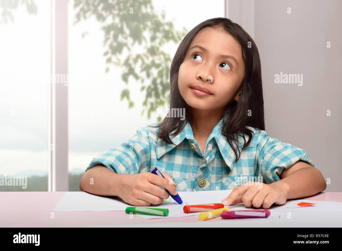 Cute asian little child drawing with colorful crayon Stock Photo - Alamy
