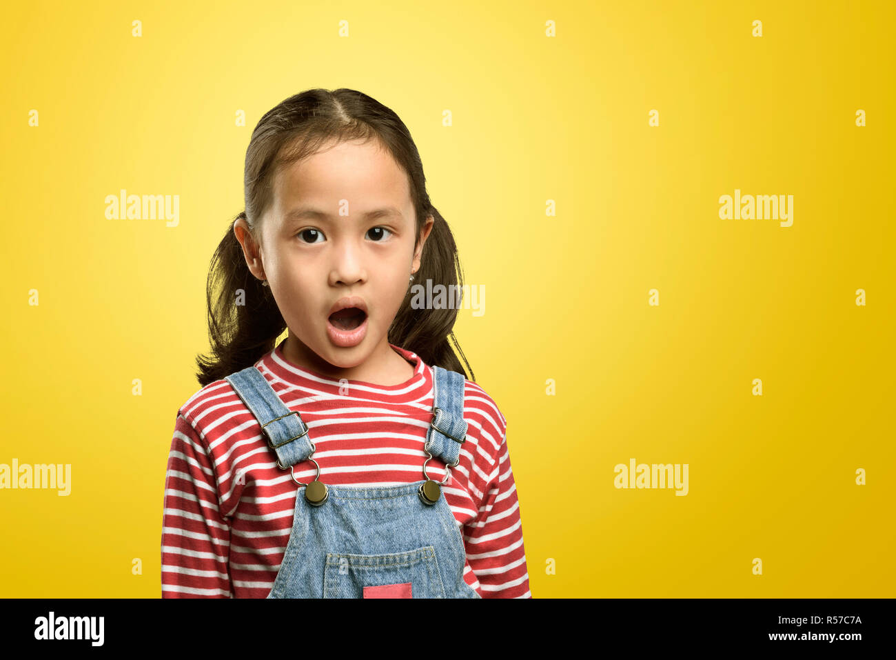 Portrait of asian kid with funny shocked face expression Stock Photo ...
