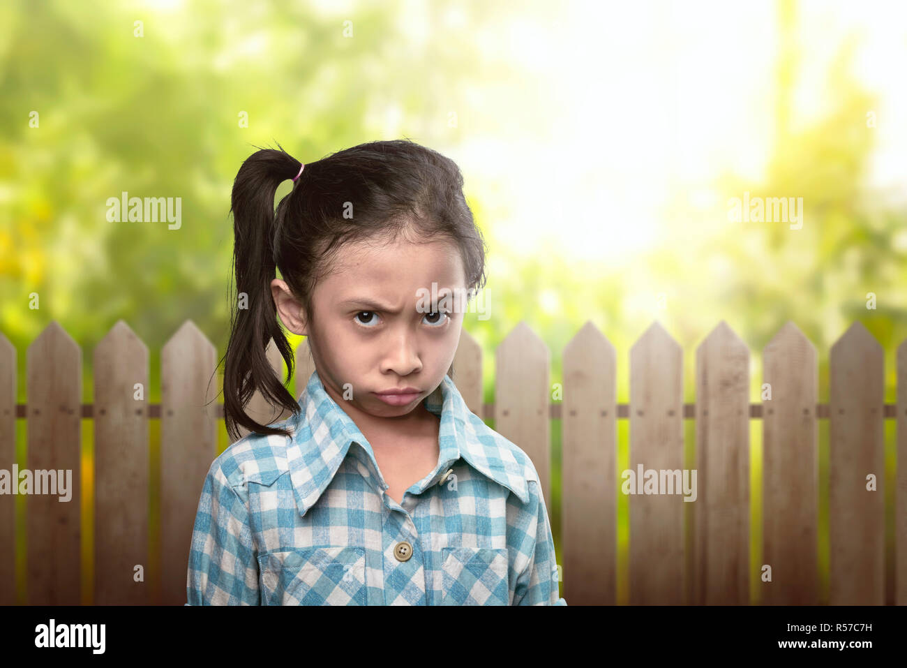 Sad asian kid in blue clothes with disbelief expression Stock Photo - Alamy