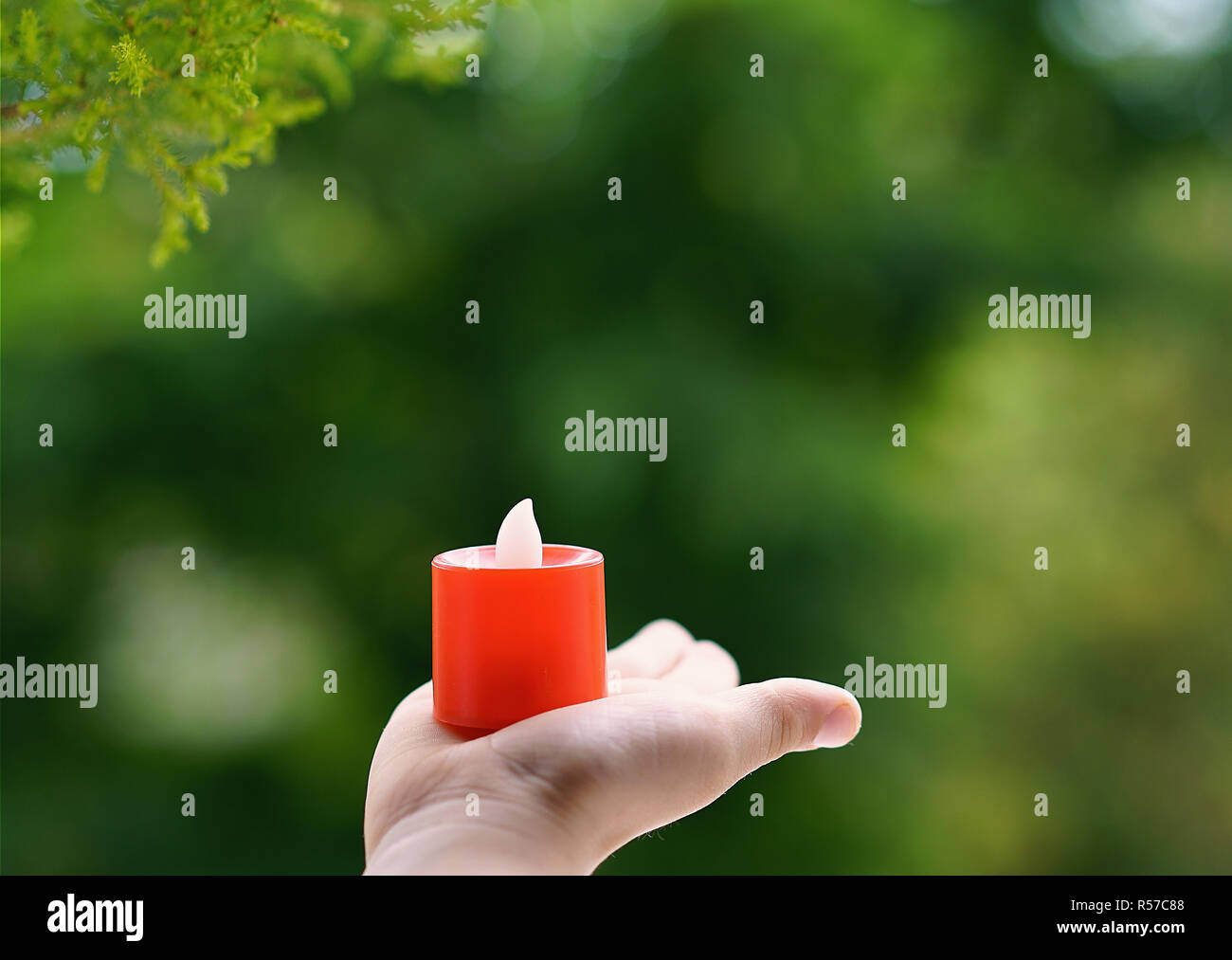Red Toy Candle in a hand Stock Photo - Alamy