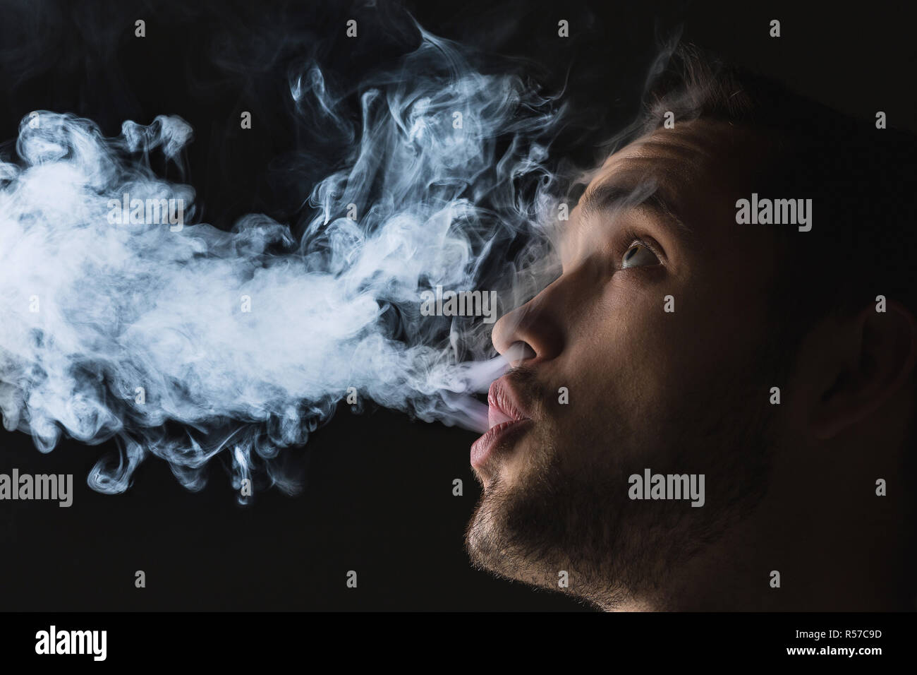 The face of vaping young man Stock Photo - Alamy