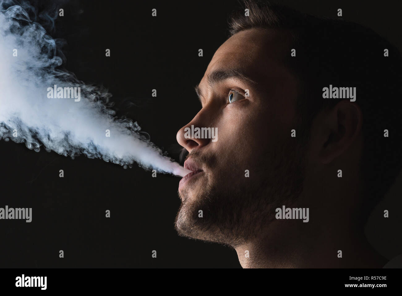 The face of vaping young man Stock Photo - Alamy