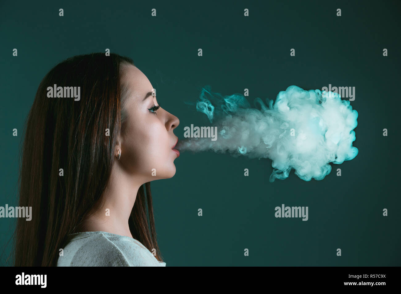 The face of vaping young woman at black studio Stock Photo - Alamy