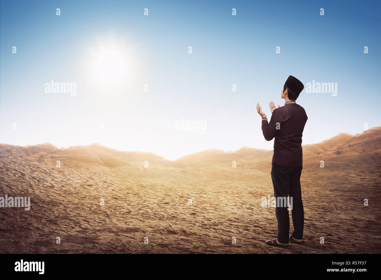 Back view of asian muslim man standing and praying Stock Photo - Alamy