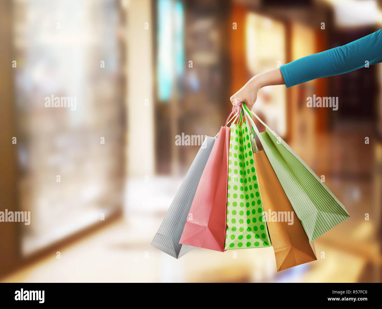 People hand holding colorful shopping bag Stock Photo - Alamy