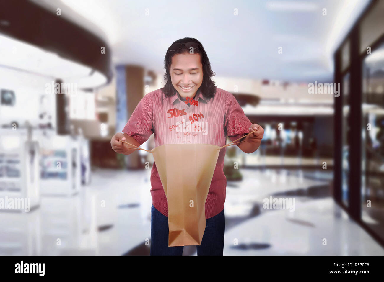 Shocking long haired man open shopping bag Stock Photo - Alamy