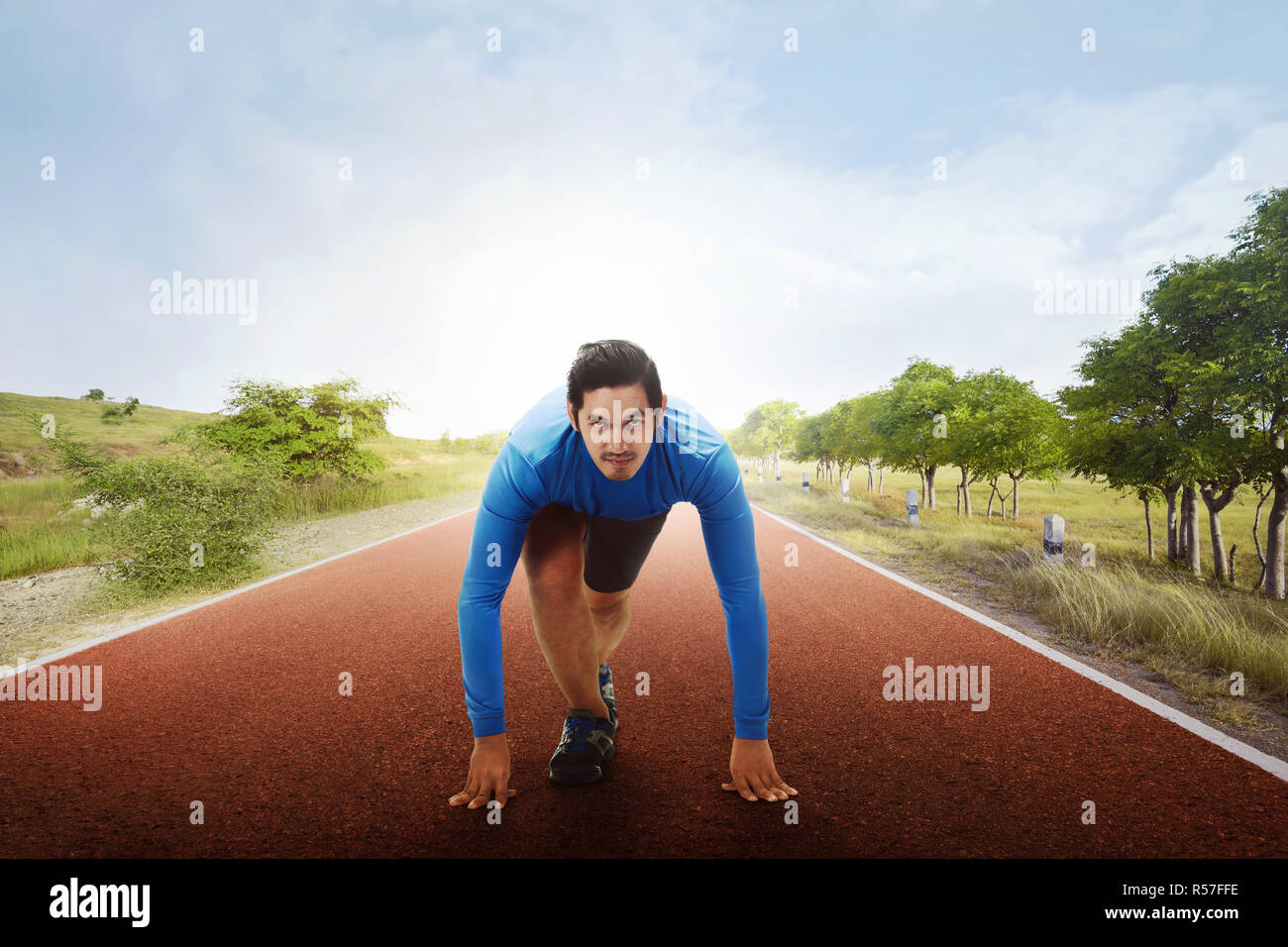 Athlete asian man on starting line ready to running Stock Photo - Alamy