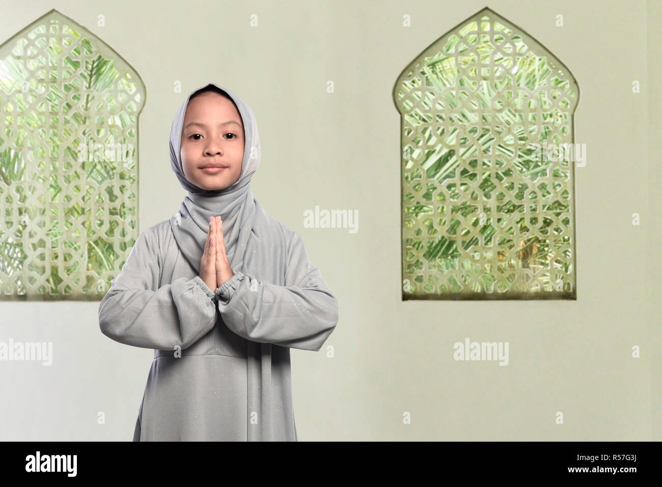 Little asian muslim kid with veil praying to go Stock Photo - Alamy