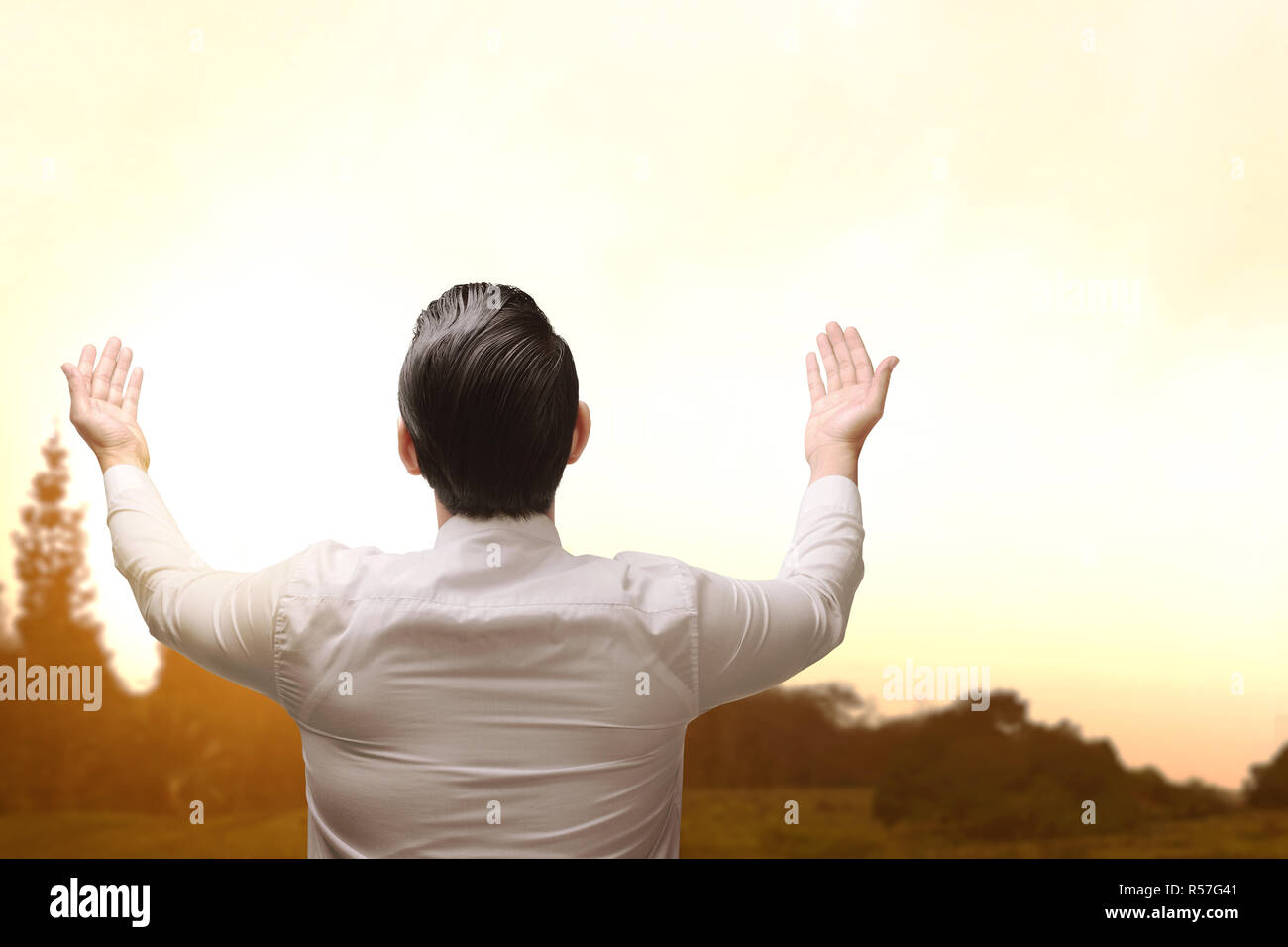 Back view of asian muslim man raising hand and praying Stock Photo - Alamy