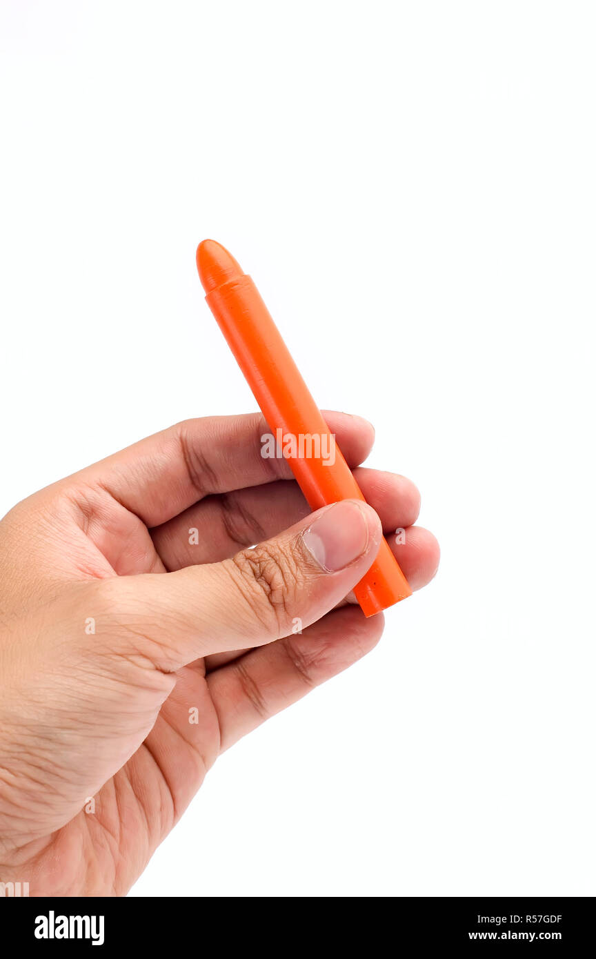 Hand Holds Orange Crayon Stock Photo - Alamy