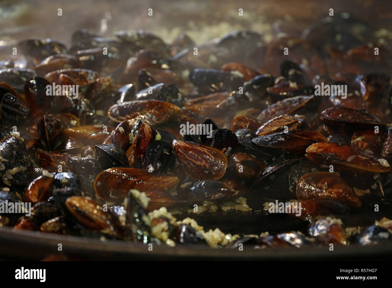 Cooking steamed roasted mussels close up Stock Photo - Alamy
