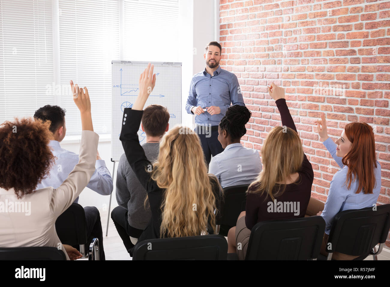 Diverse group colleagues raising hi-res stock photography and images ...