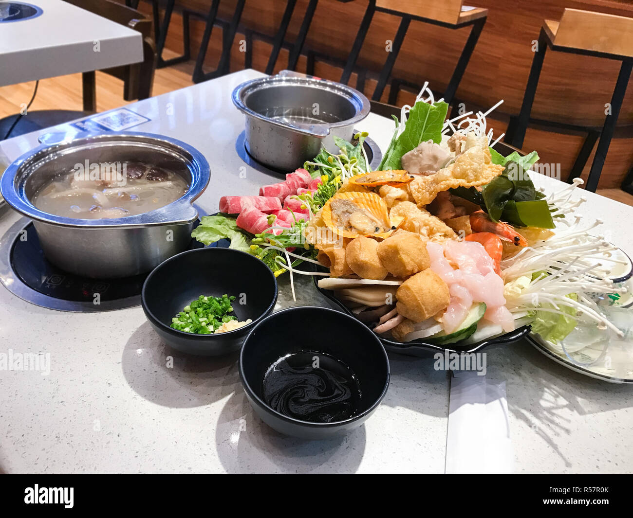 dinner with chinese seafood hot pots Stock Photo - Alamy