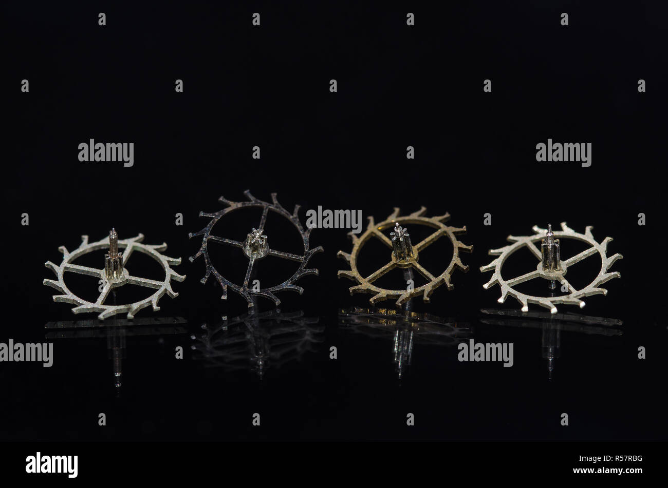 Watch Parts: Four Vintage Metallic Escape Wheels on Black Background ...