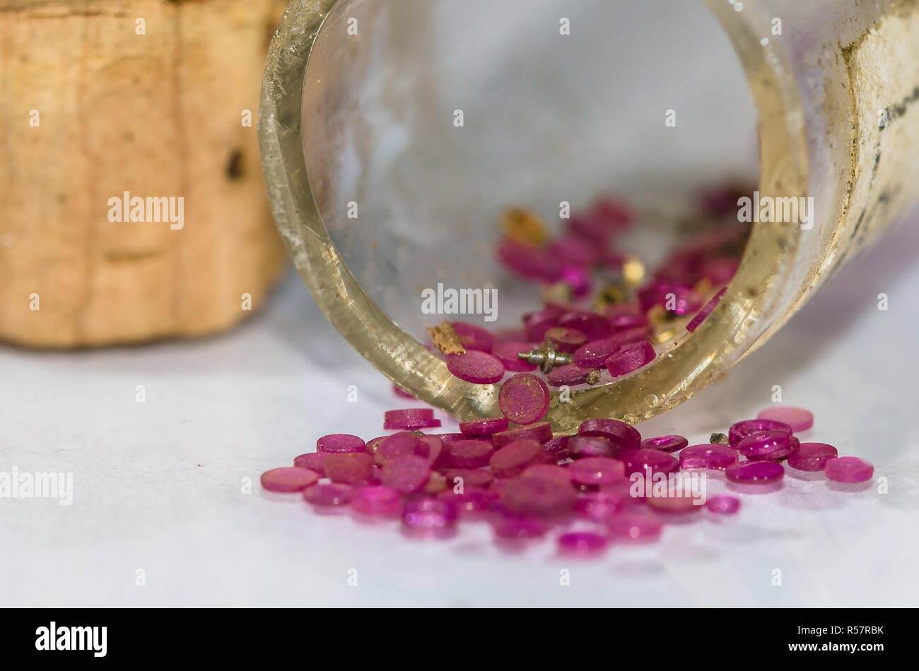Watch Parts: Cap Jewels Spilling from Corked Vial Stock Photo - Alamy