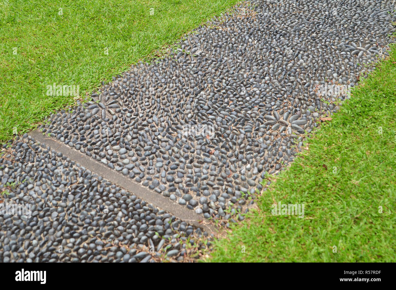 Stone walk path with green grass Stock Photo - Alamy