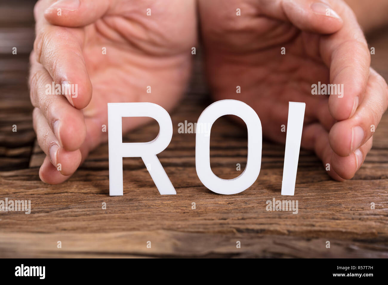 Person's Hand Protecting ROI Text Stock Photo - Alamy