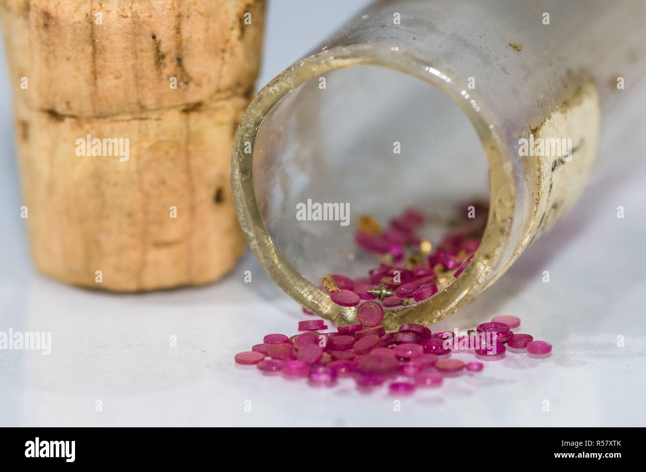 Watch Parts: Cap Jewels Spilling from Corked Vial Stock Photo - Alamy