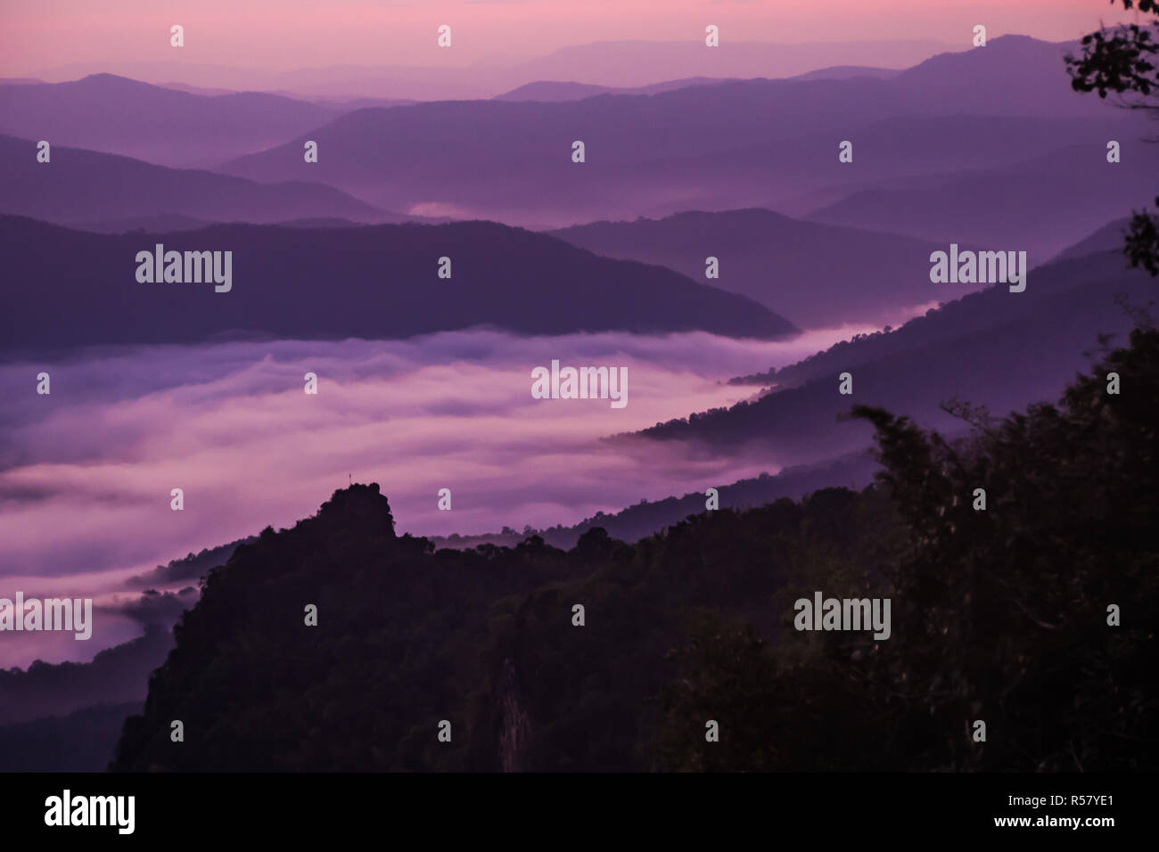 sunset overlooking mountains with Mist Stock Photo - Alamy