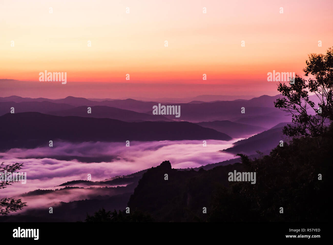 sunset overlooking mountains with Mist Stock Photo - Alamy