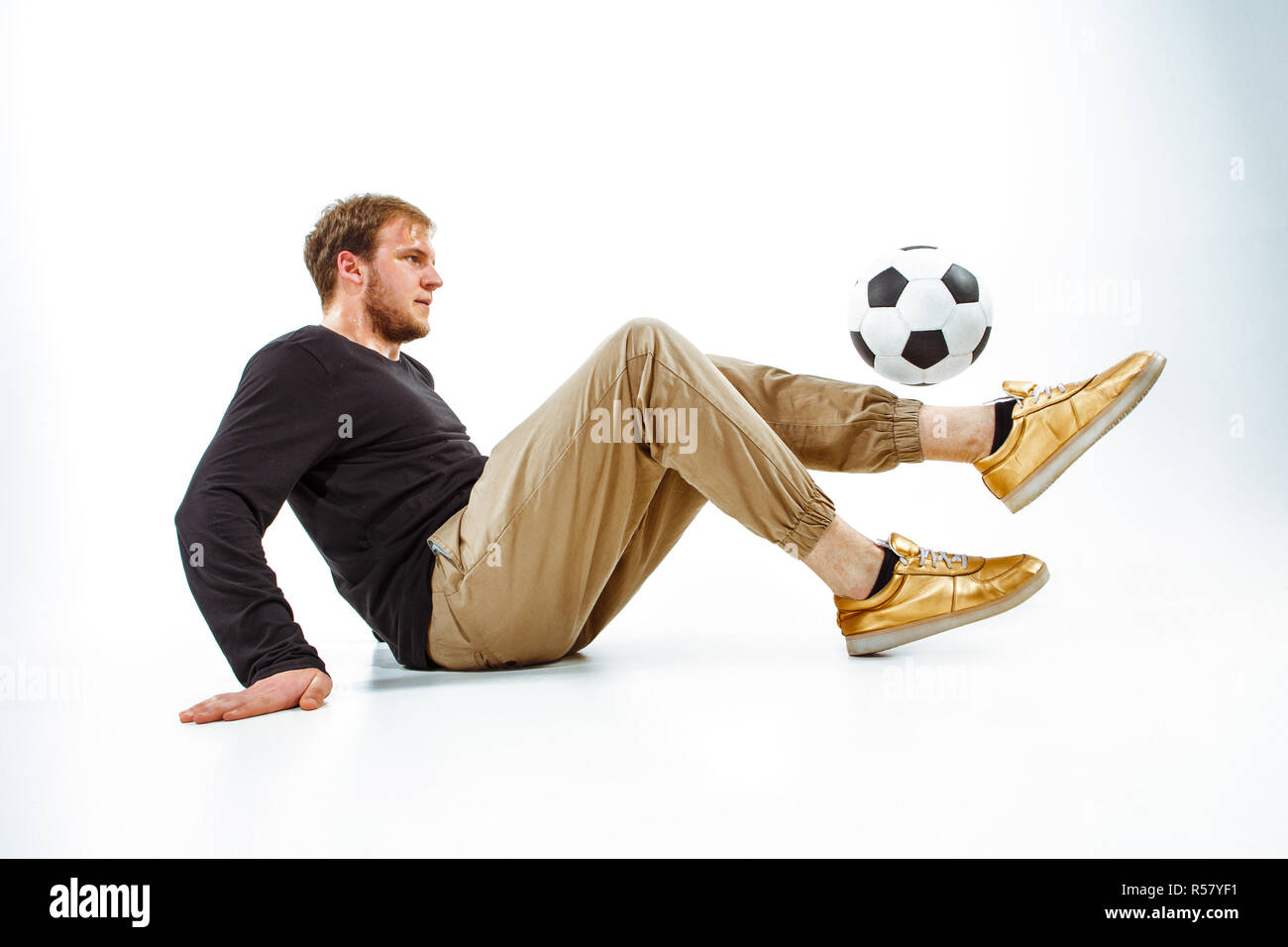 A portrait of a fan with ball on gray studio background. Freestile ...